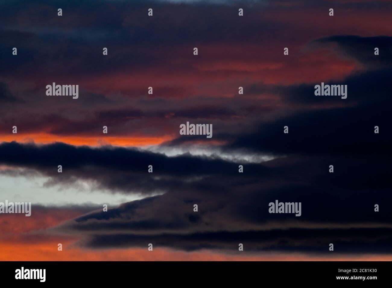 Colorful cloud patterns with golden hour light Stock Photo - Alamy