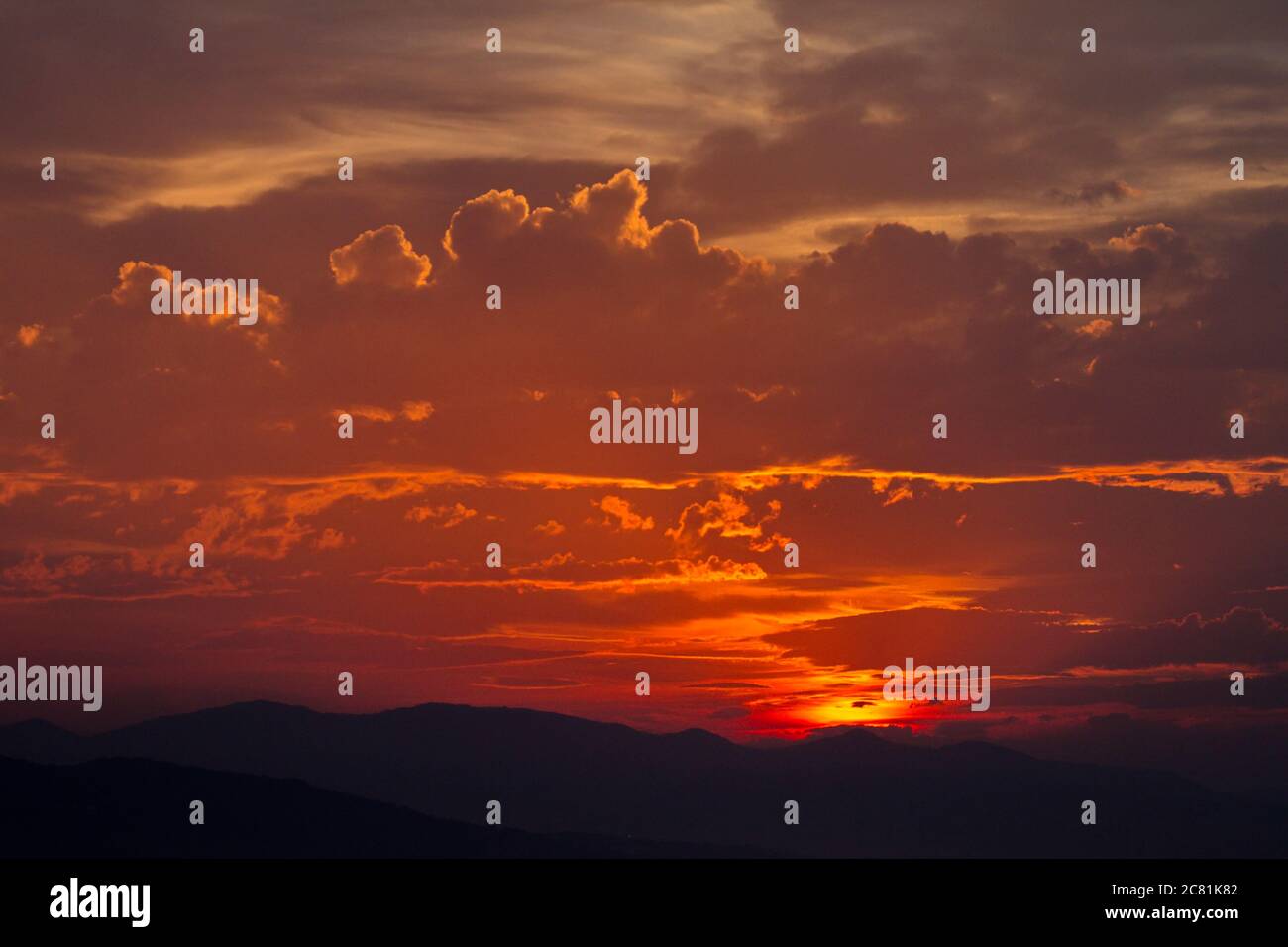 Colorful cloud patterns with golden hour light Stock Photo - Alamy