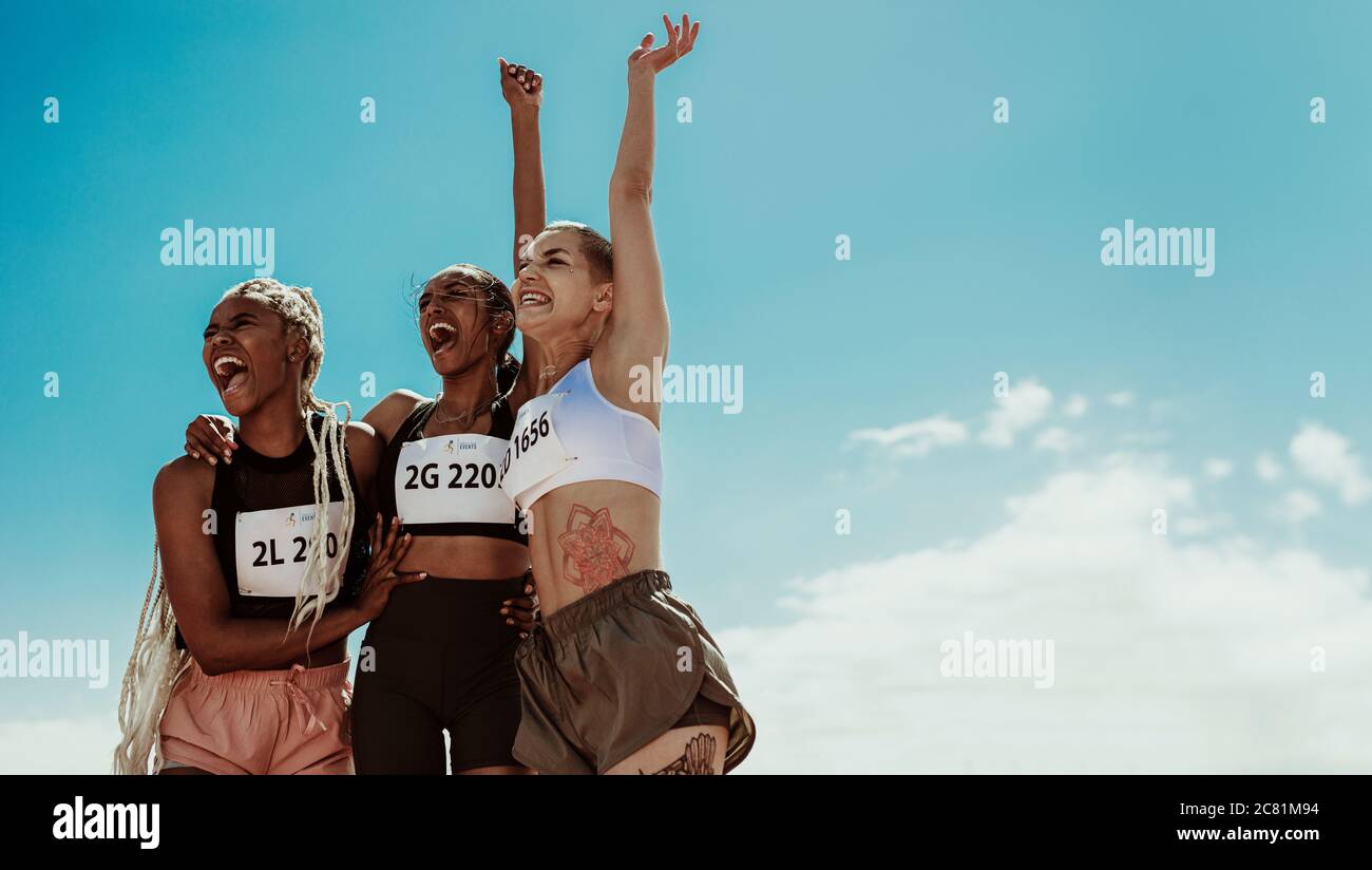 Young team of female athletes enjoying victory. Diverse group of ...