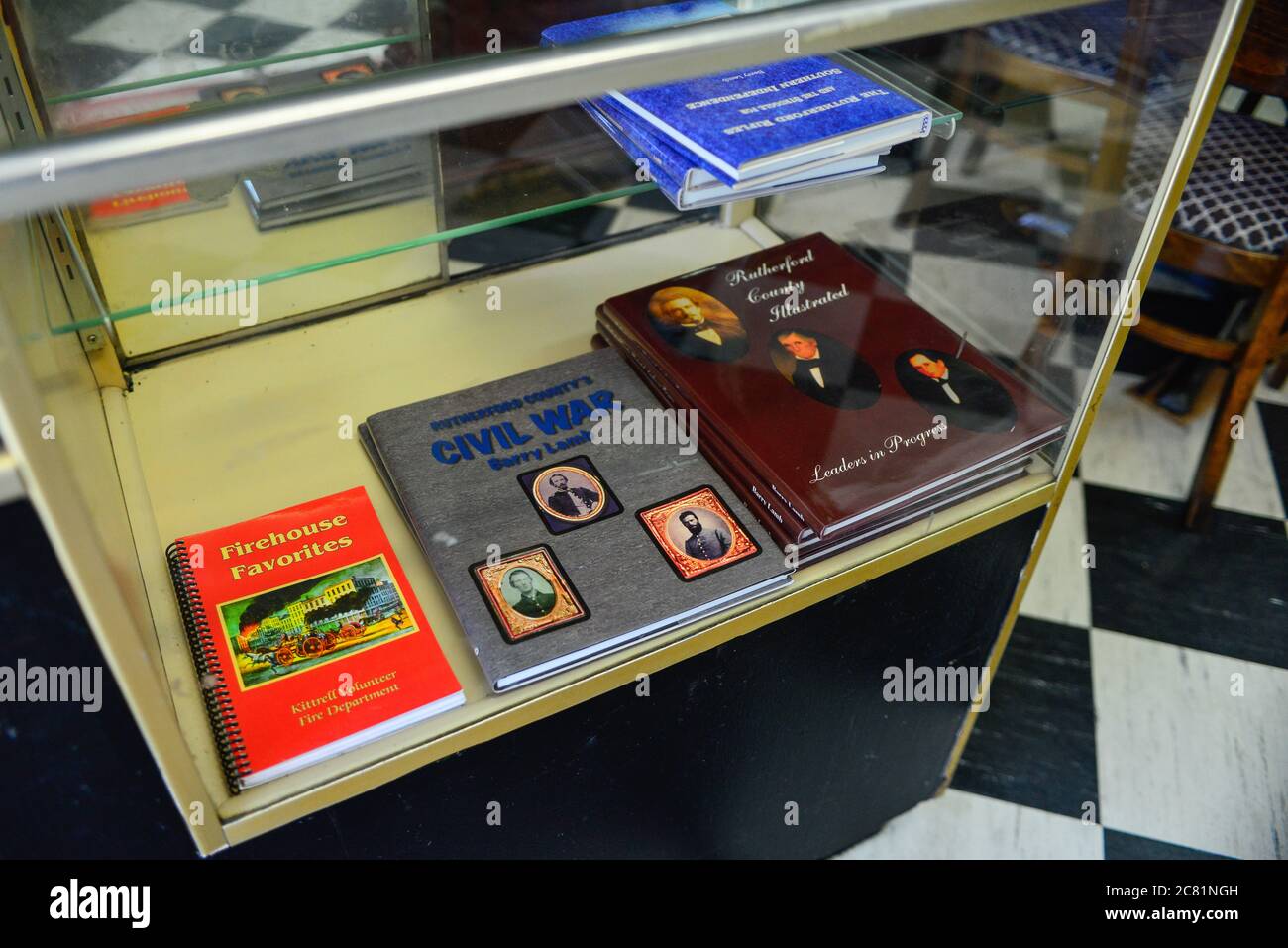 Glass display case at the City Cafe register area offering books on the ...