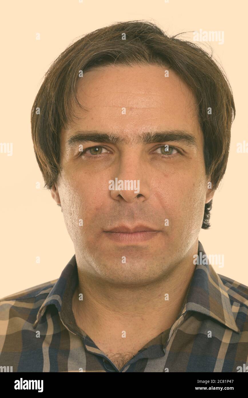 Studio shot of face of young Persian man Stock Photo - Alamy