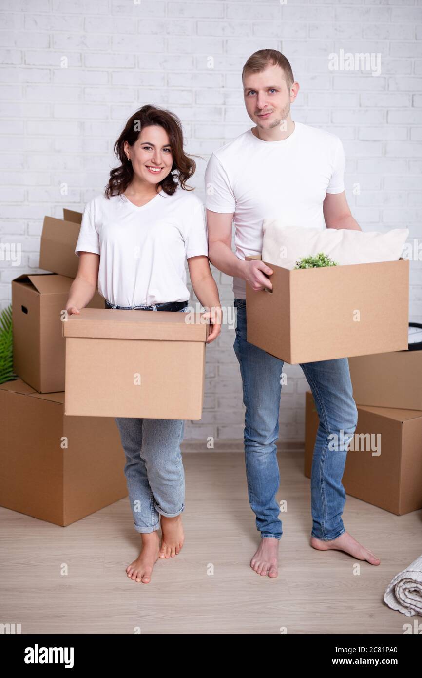 Moving Day Concept Happy Young Couple Packing Moving Cardboard Boxes