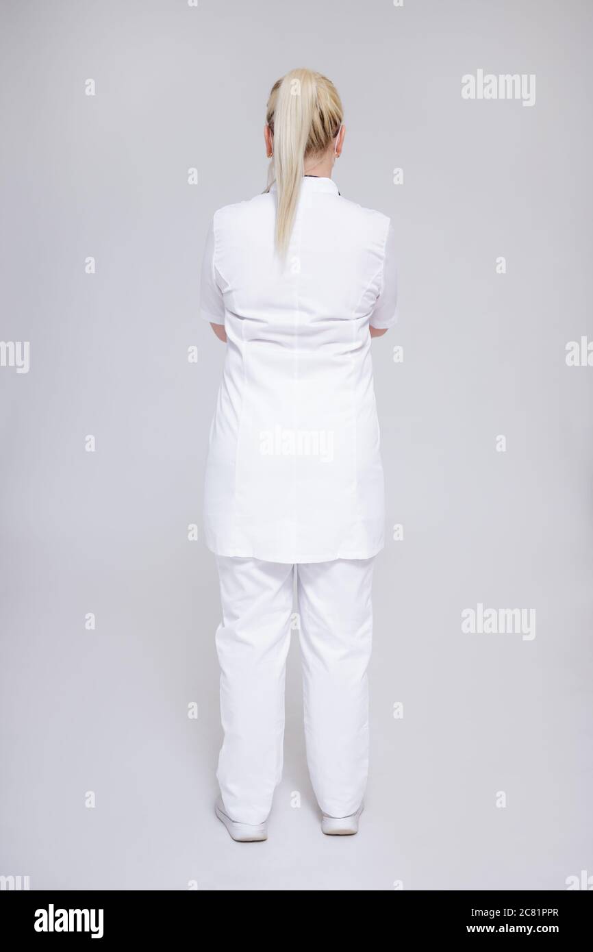 back view of female doctor or nurse in white uniform over gray ...