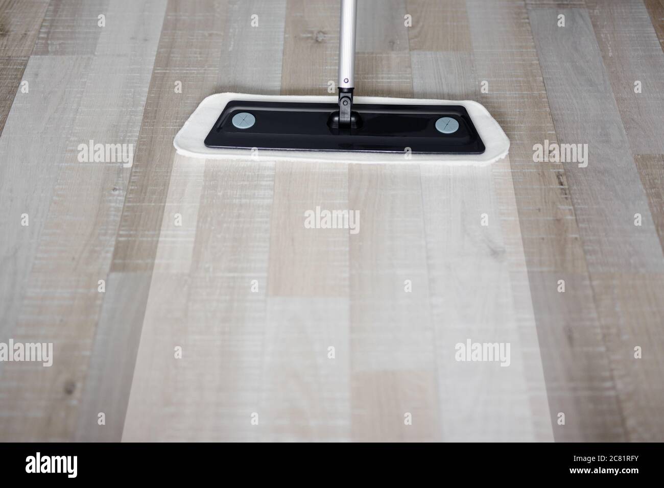 cleaning, before and after concept - close up of wooden floor with mop ...
