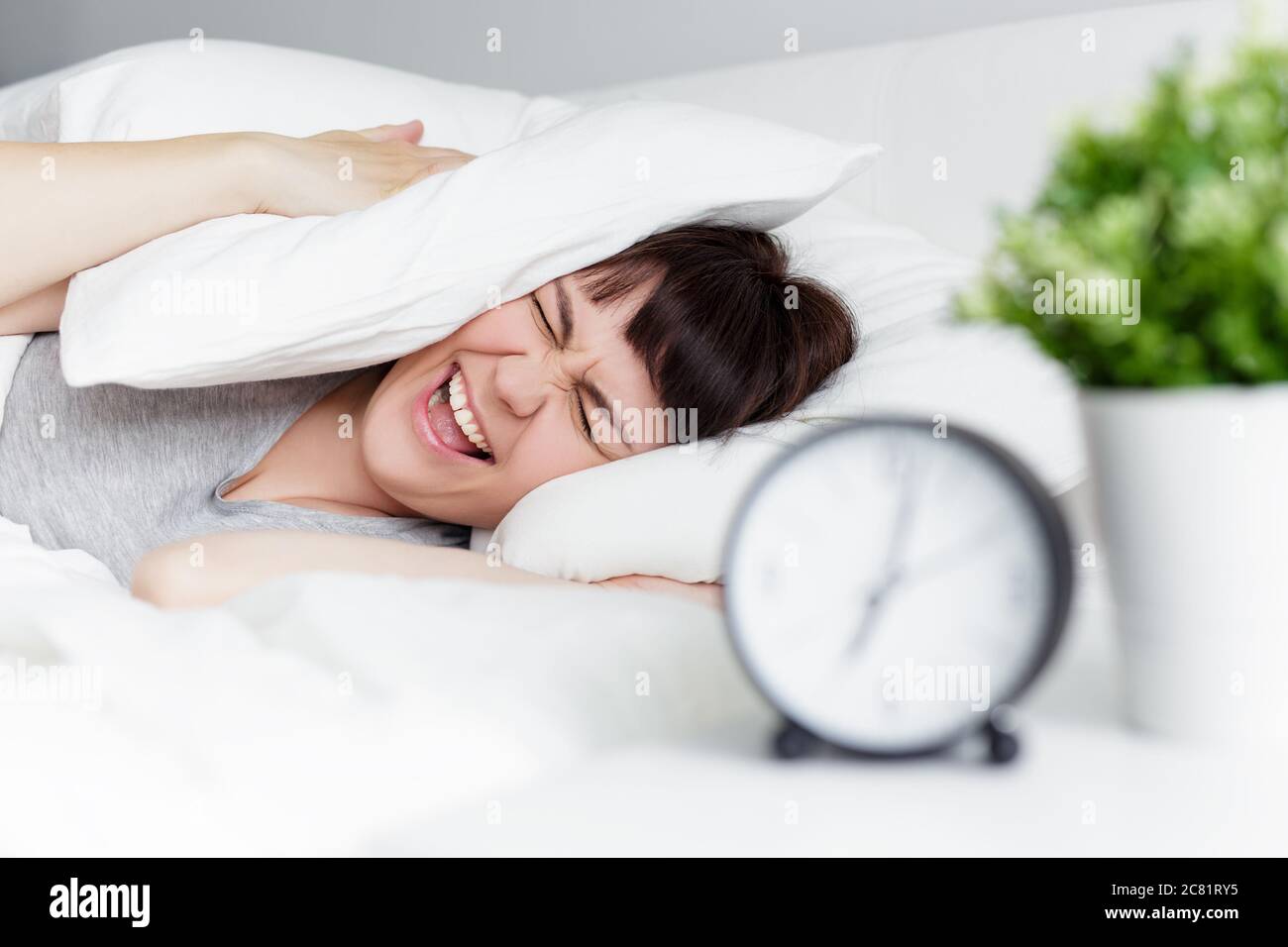 stress, insomnia and routine concept - woman waking up with alarm clock ...