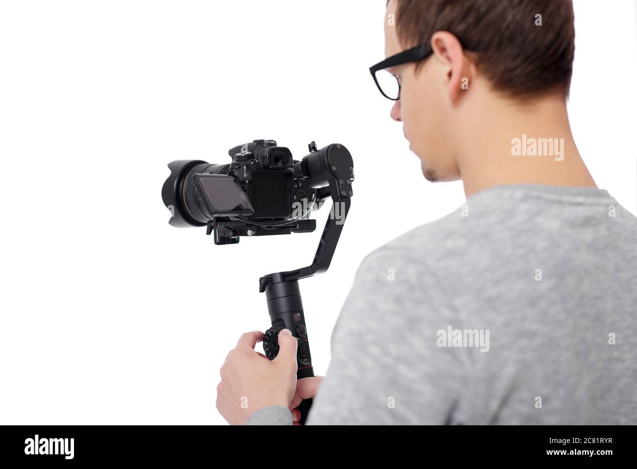 back view of professional videographer using dslr camera on gimbal ...