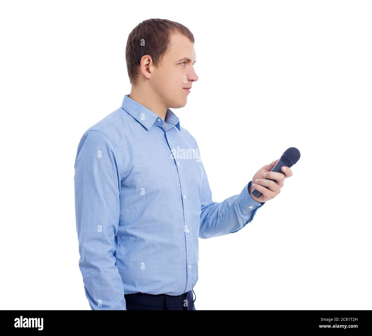 side view of young male journalist or reporter with microphone ...
