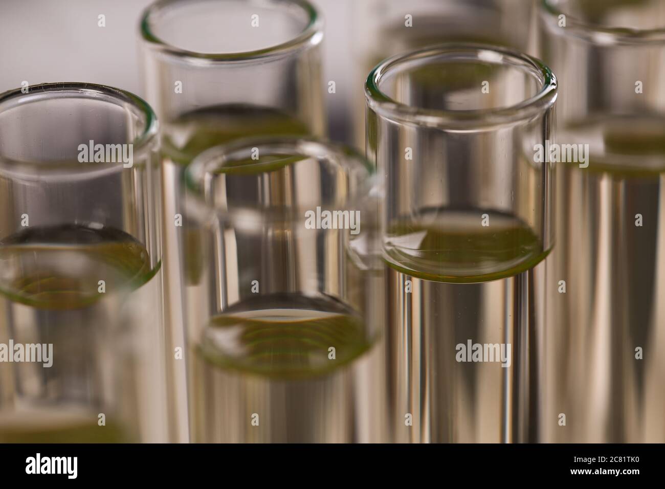 Test tubes in special handles with yellow liquids Stock Photo - Alamy