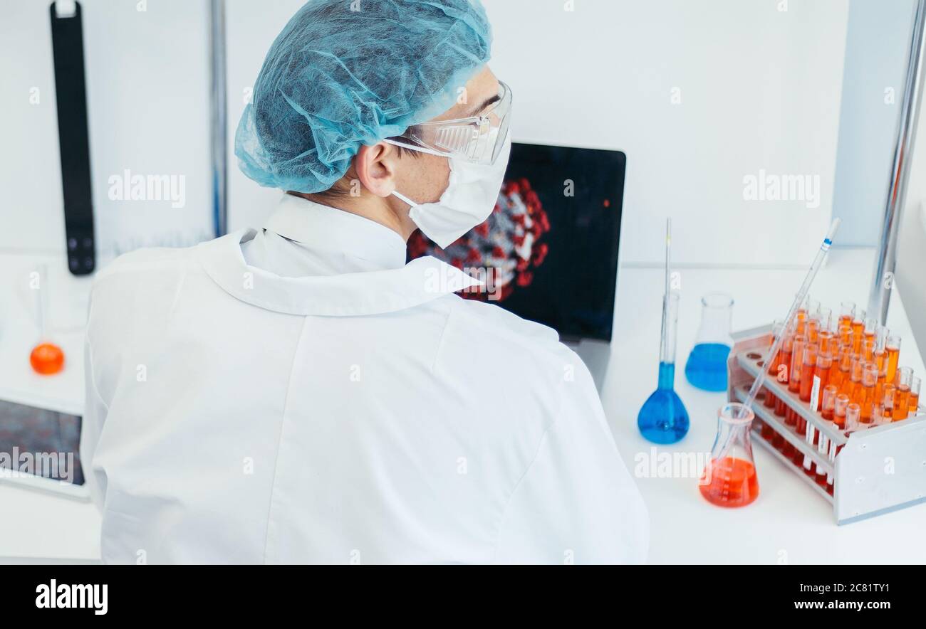 rear view. scientist sitting at a Desk in the laboratory Stock Photo ...