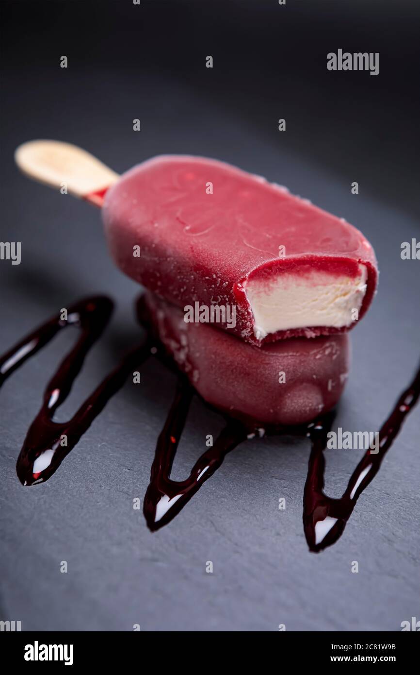 Fruit ice cream stick looks fresh to eat placed on a black background ...