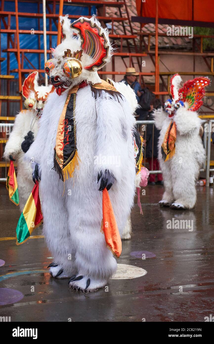 Diablada dancers in white bear costumes parade through the mining city ...