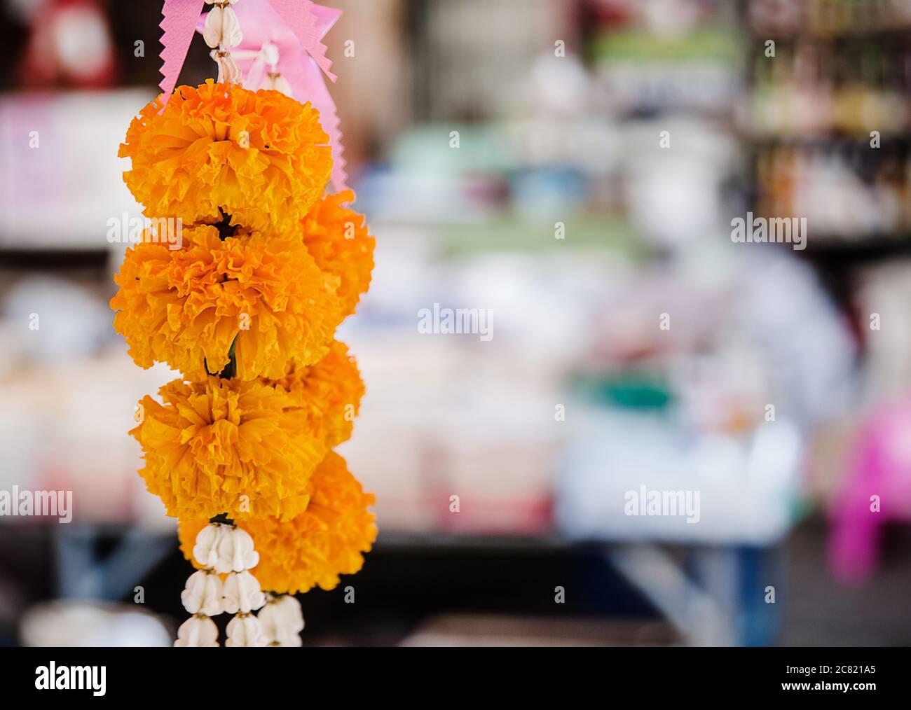 String of prayer flowers, Southeast asia Stock Photo - Alamy