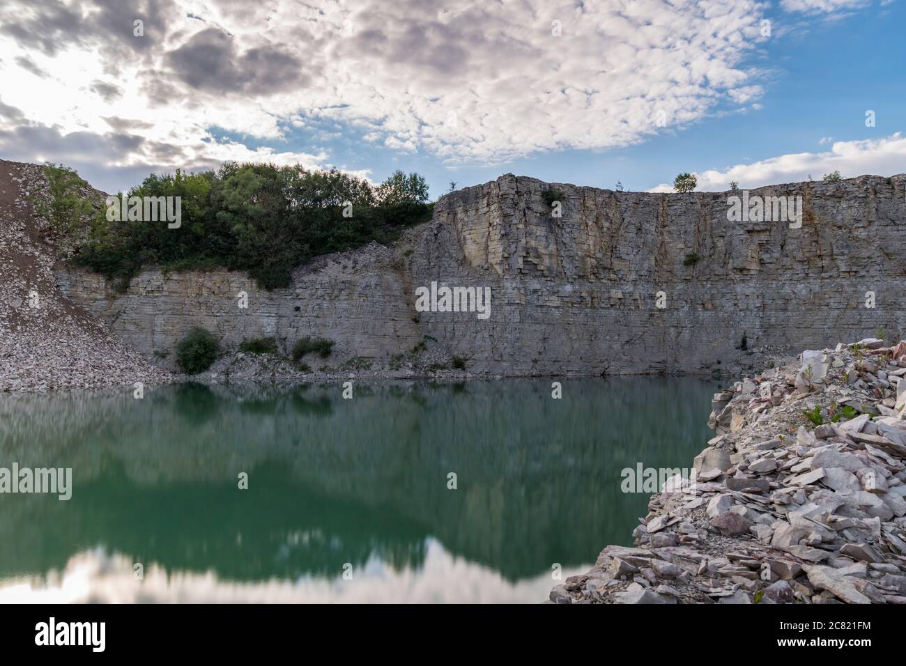 Green stone quarry lake on summer day Stock Photo - Alamy