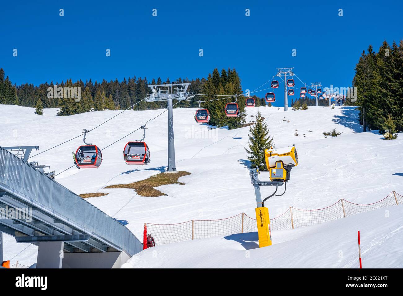 Beautiful shot of the ropeways above snow-covered mountains under a ...