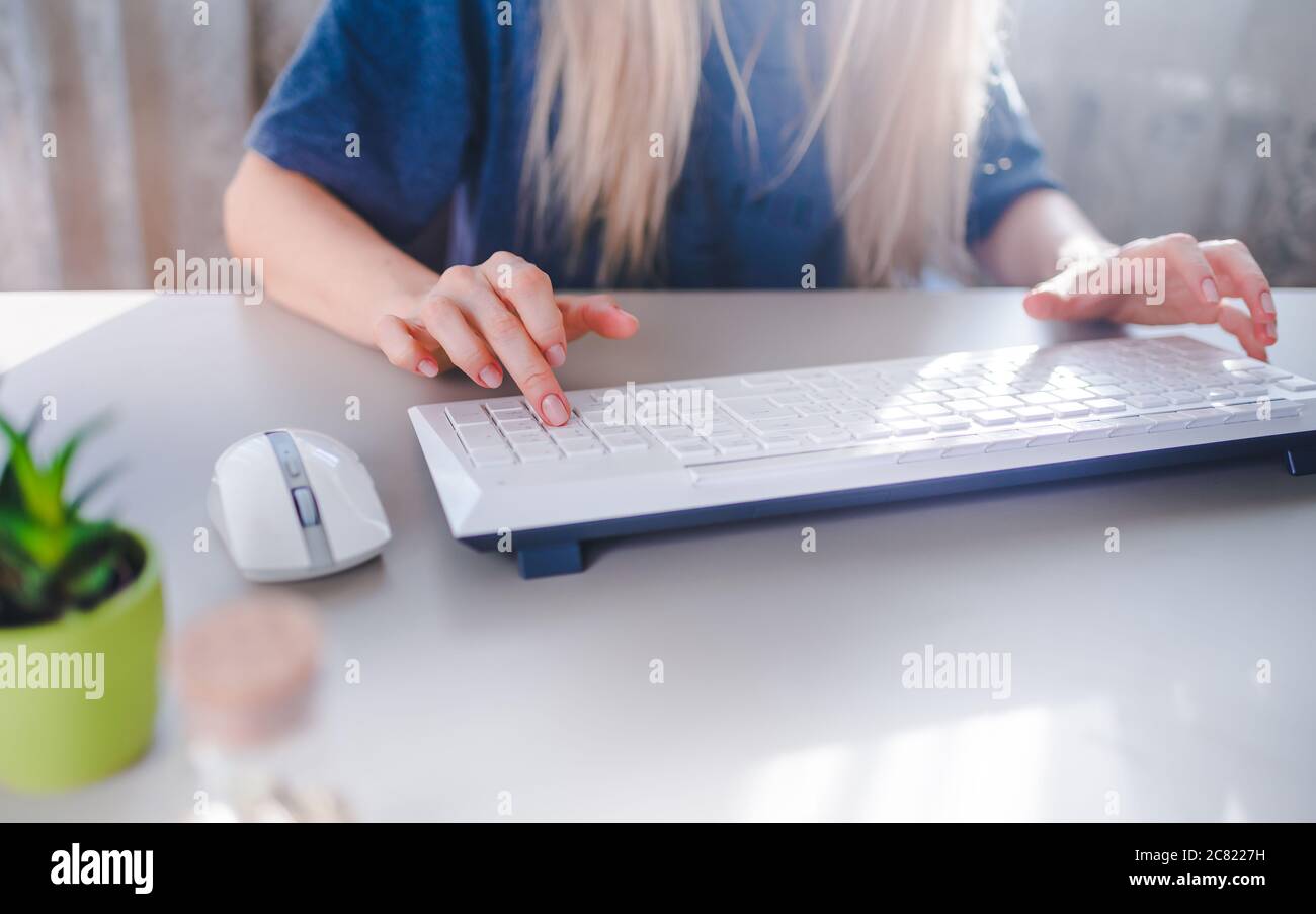 girl typing on a white keyboard and uses a mouse Stock Photo - Alamy