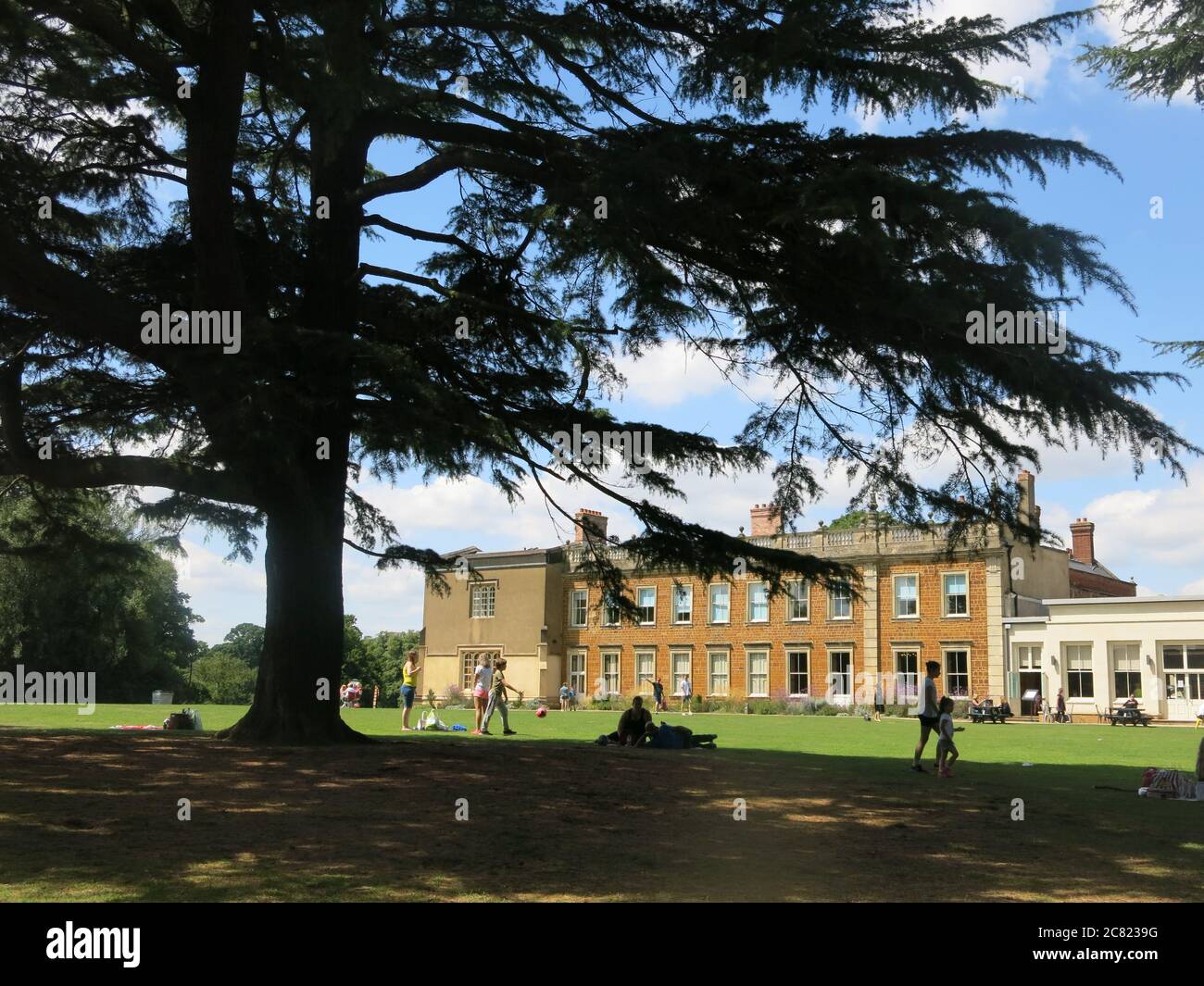 View of Delapre Abbey and its parkland framed by the branches of a ...