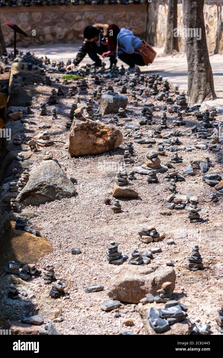 Young couple doing Zen stacking stones in Bulguksa Temple, Gyeongju ...