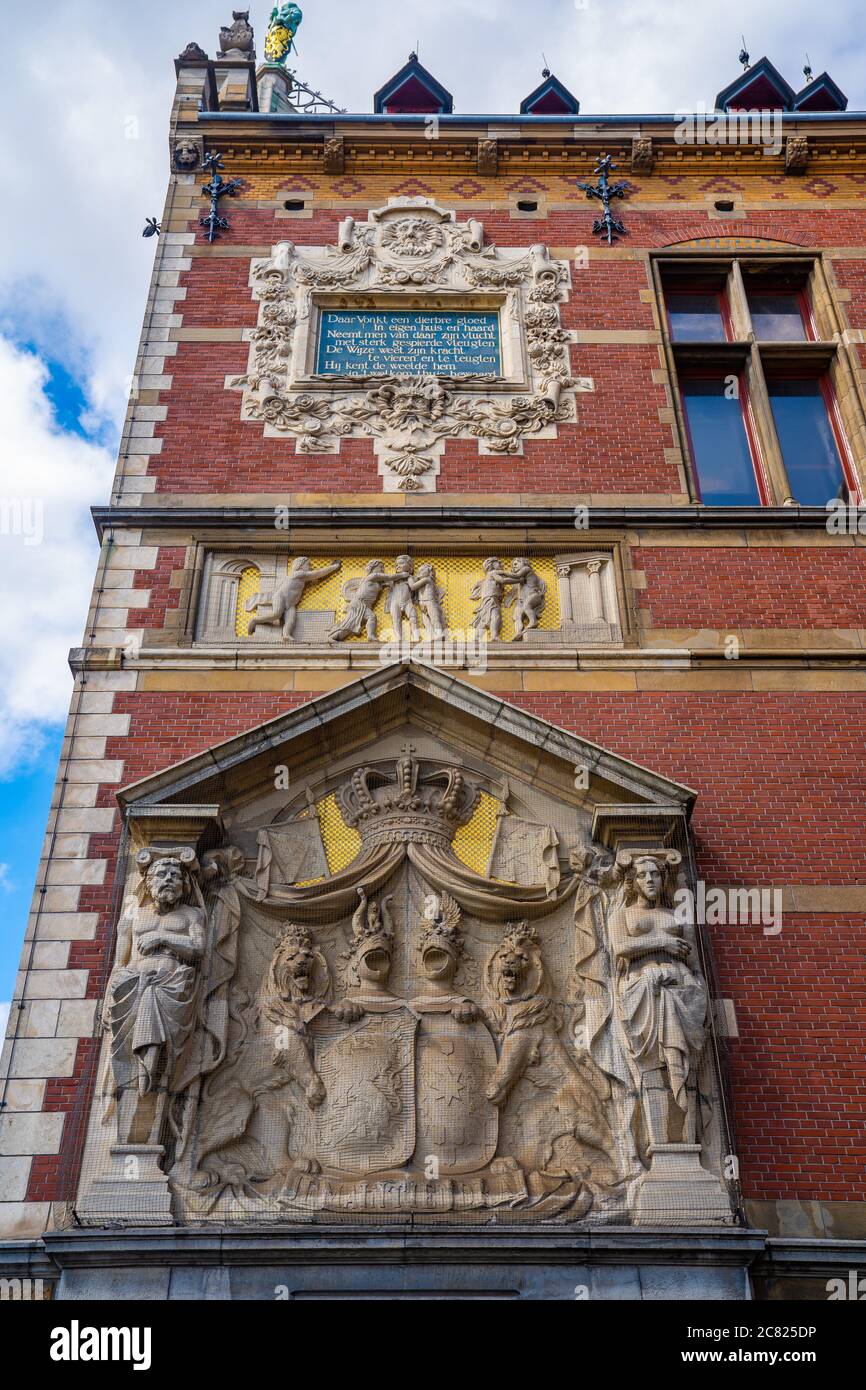 Vertical shot of an antique brick building with statues in Amsterdam ...