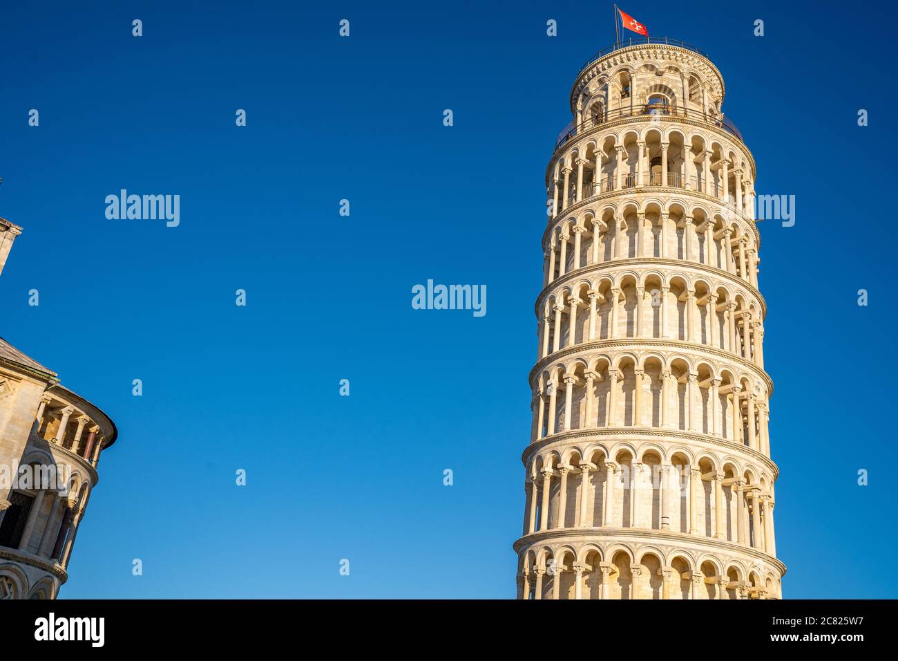 Low angle shot of the famous leaning Pisa tower under a bright sky in ...