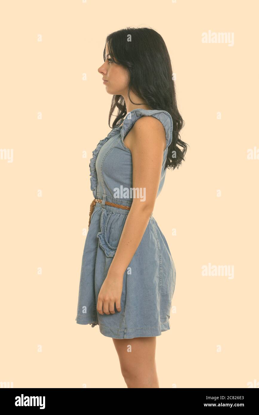 Profile view of young beautiful Spanish woman standing Stock Photo - Alamy