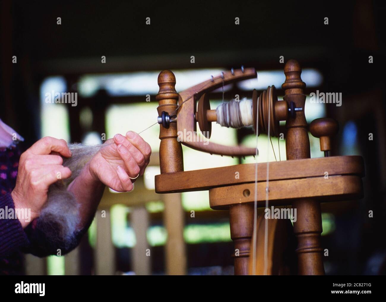 Spinning Yarn On A Spinning Wheel Stock Photo - Alamy