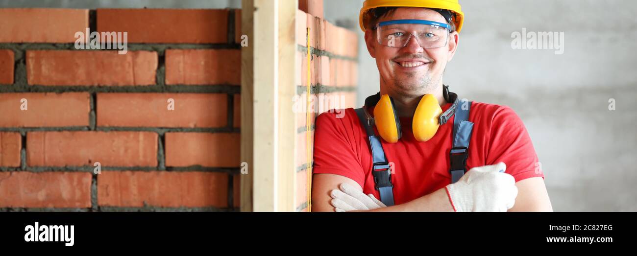 Mason or foreman standing by wall construction Stock Photo - Alamy