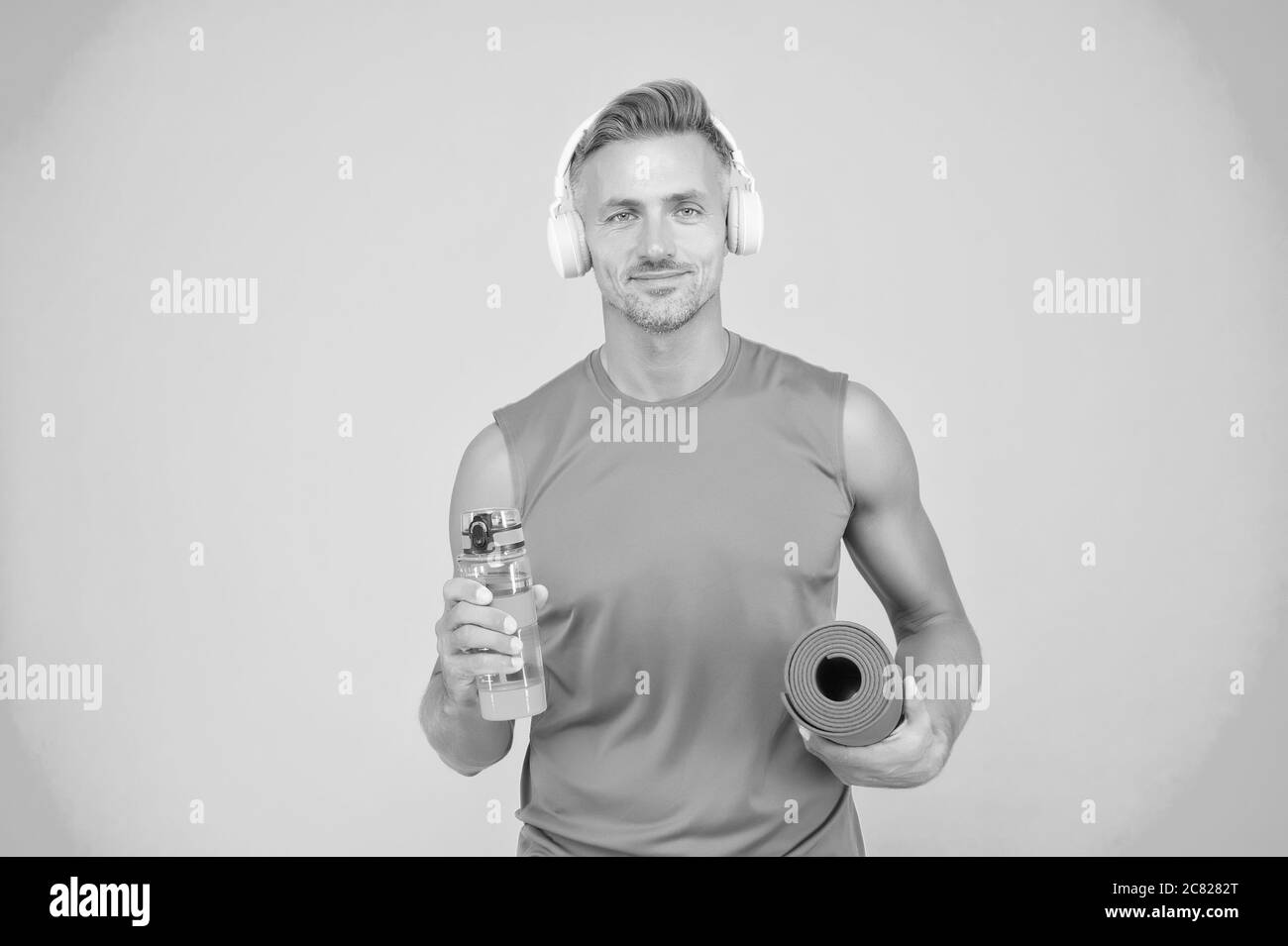 Hydration for athletes. Fit athlete gold water bottle blue background ...