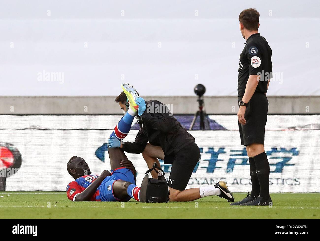 Crystal Palace's Mamadou Sakho (left) receives treatment as referee ...
