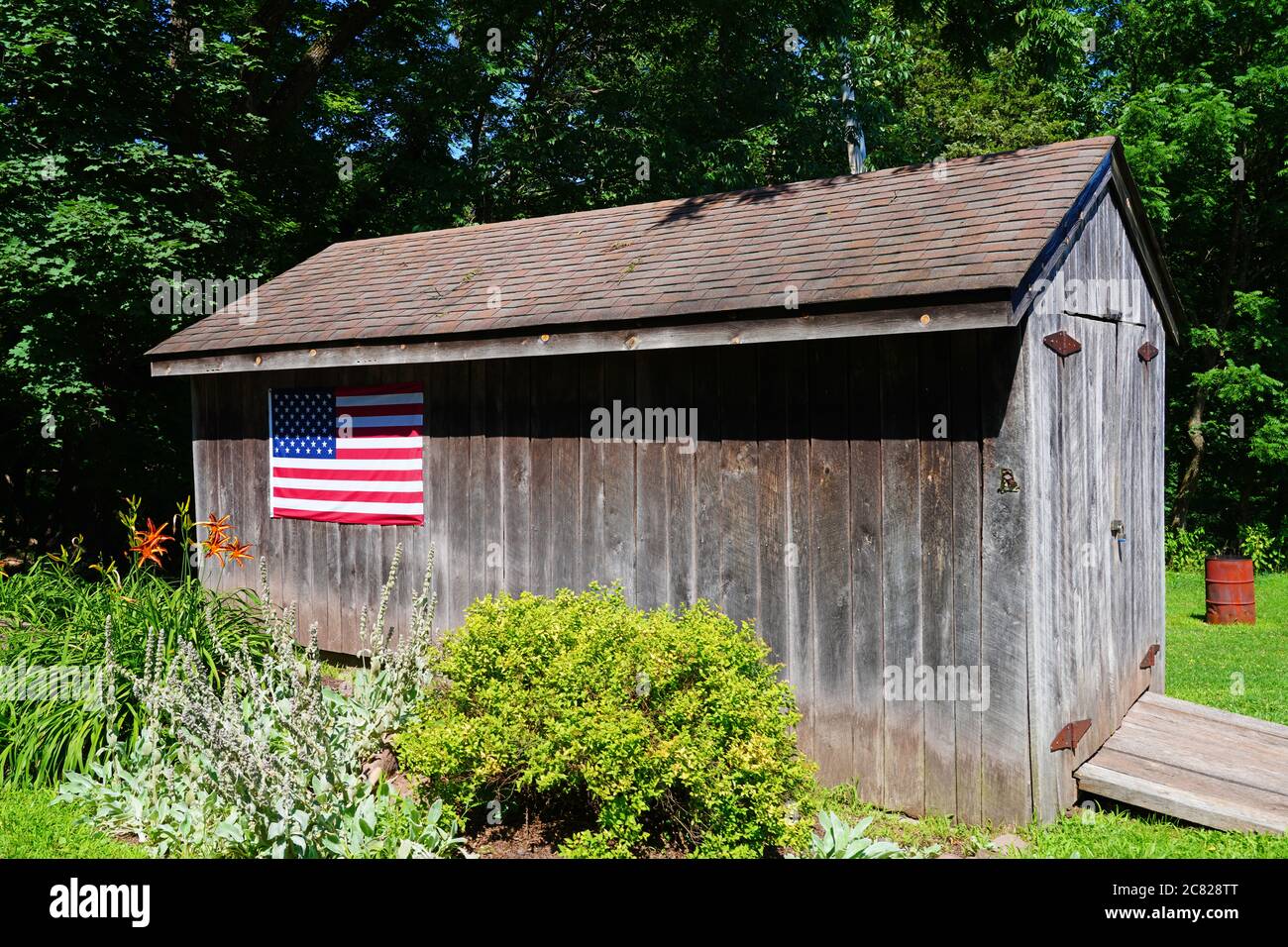 View of a traditional wooden barn with an American Flag in rural Bucks ...