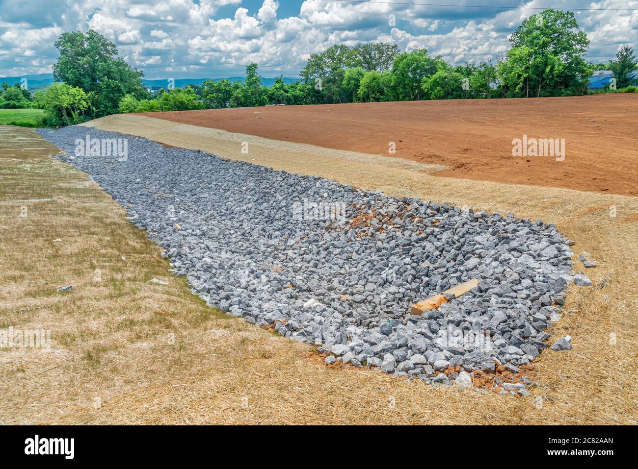 Horizontal shot of a rock lined ditch under construction Stock Photo ...