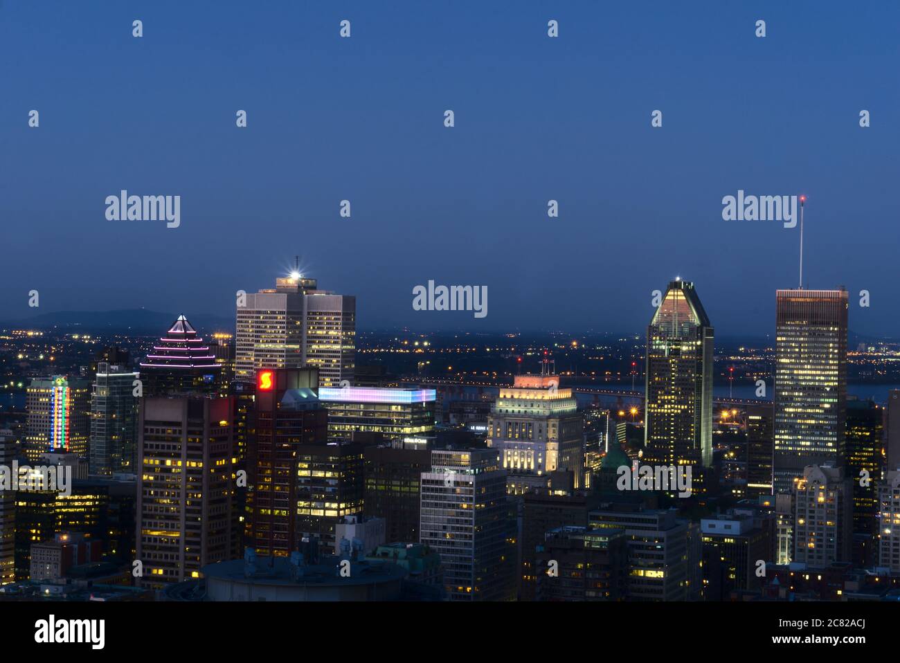 A skyline view of a city illuminated skyscrapers, buildings, and ...