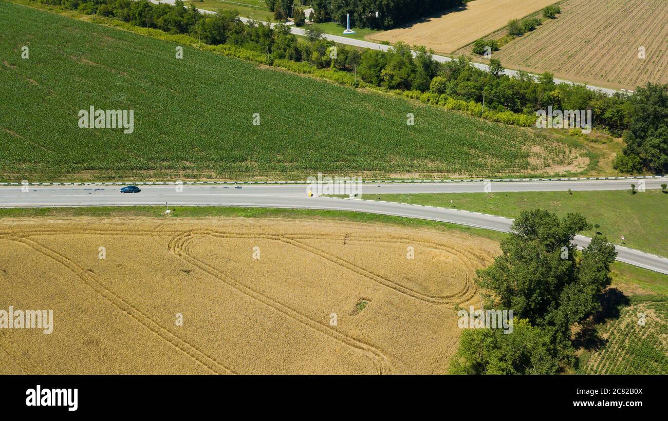 Aerial view of a country road in beautiful agricultural fields in ...