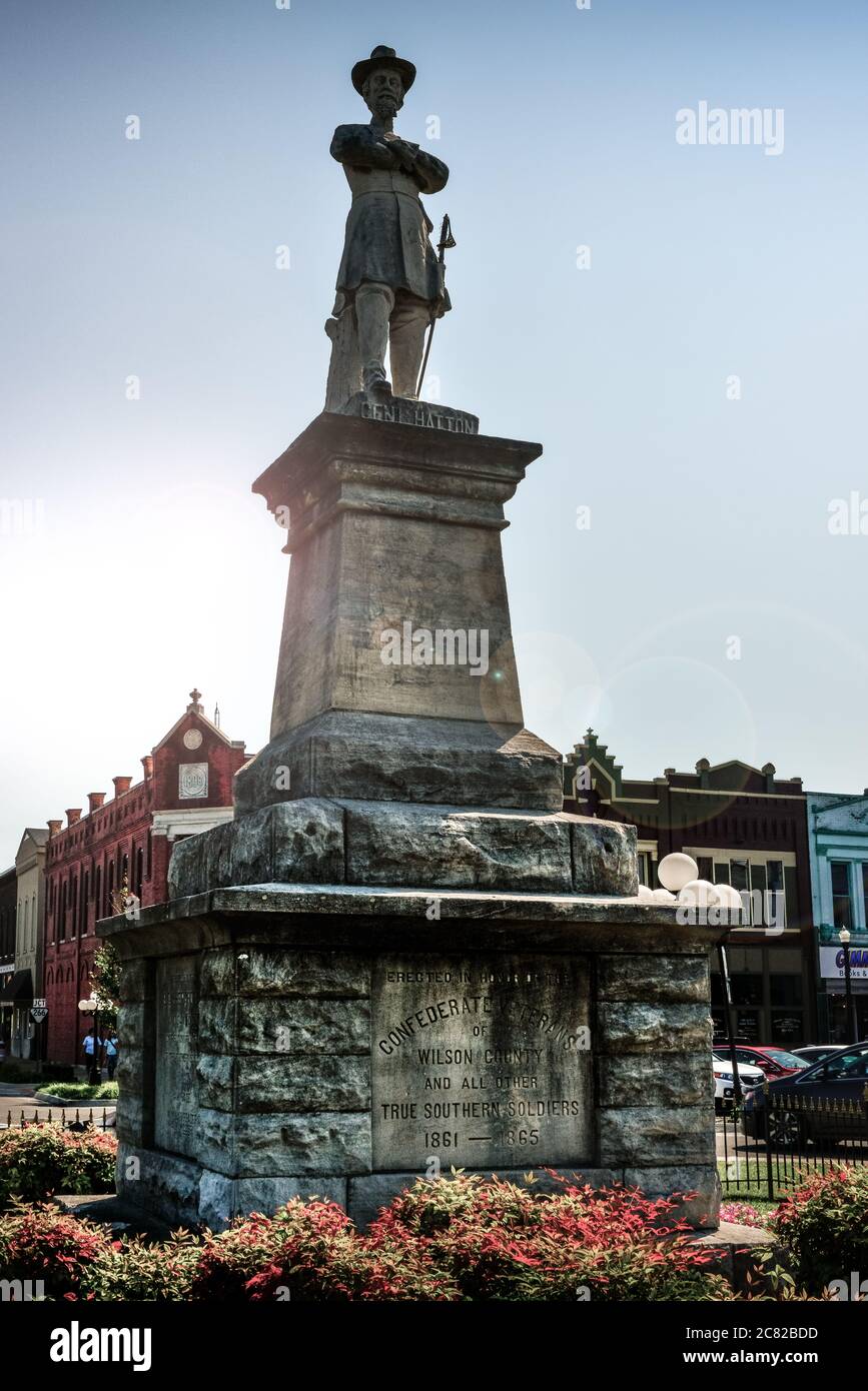 Sun flares around the Confederate General Hatton statue on stone plinth ...
