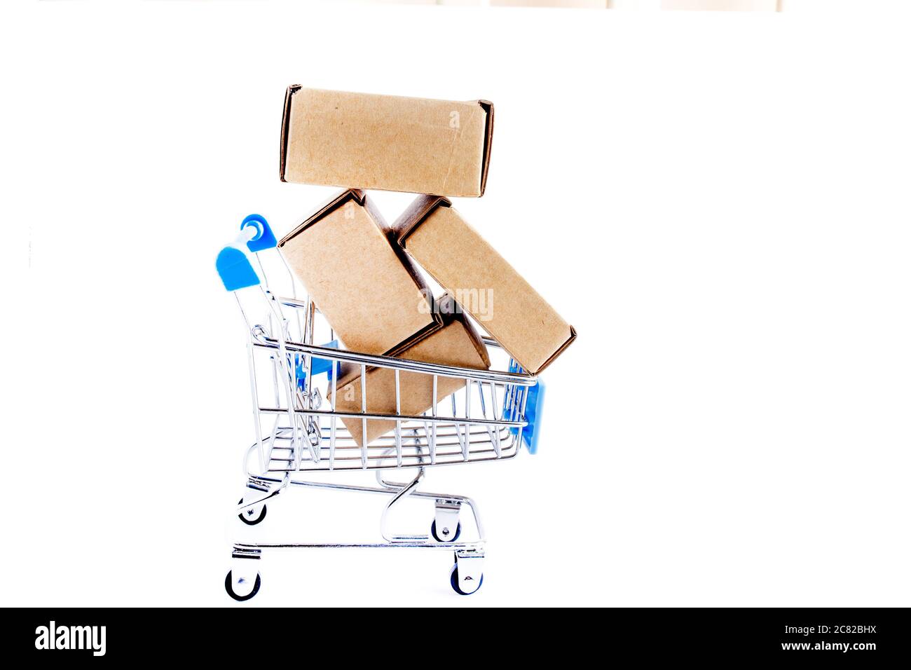 Shopping cart full of cardboard boxes, isolated on white background ...