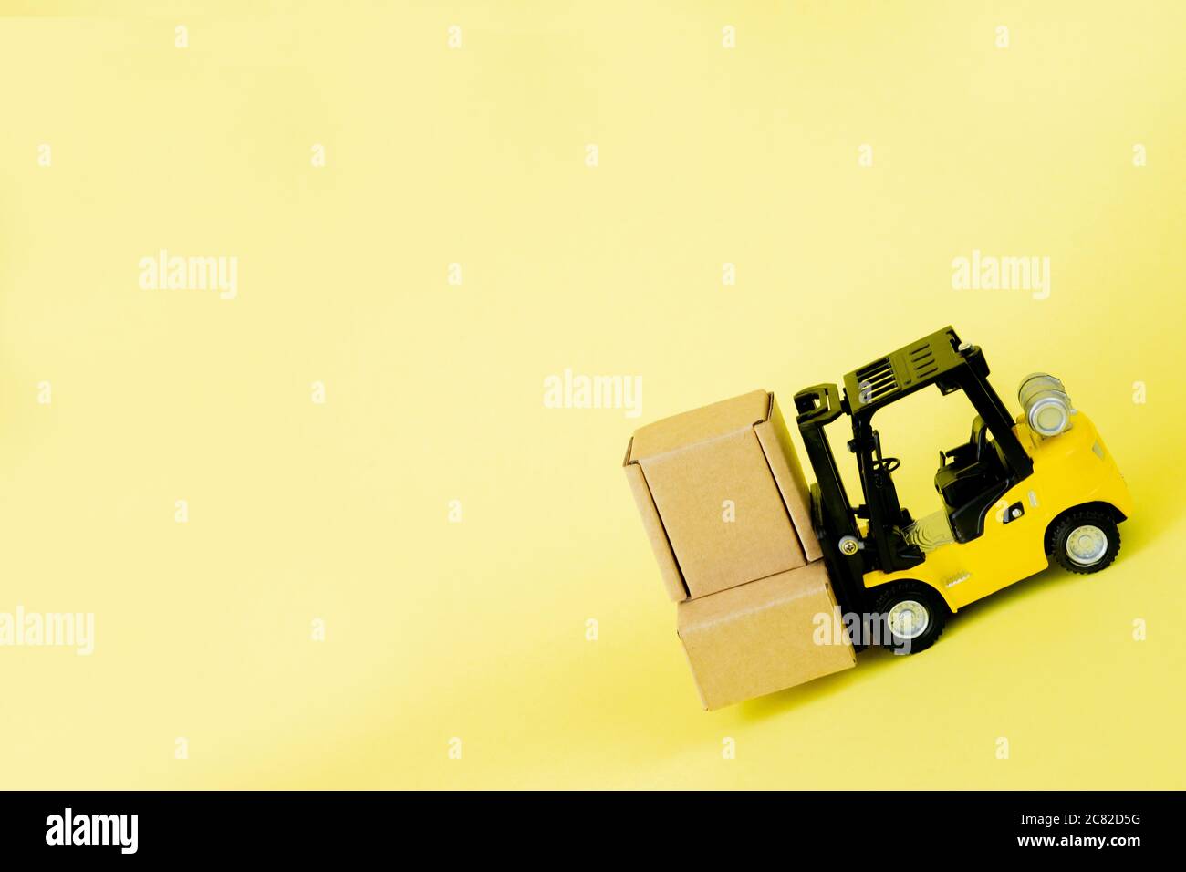 Mini forklift truck load cardboard boxes. Logistics and transportation ...