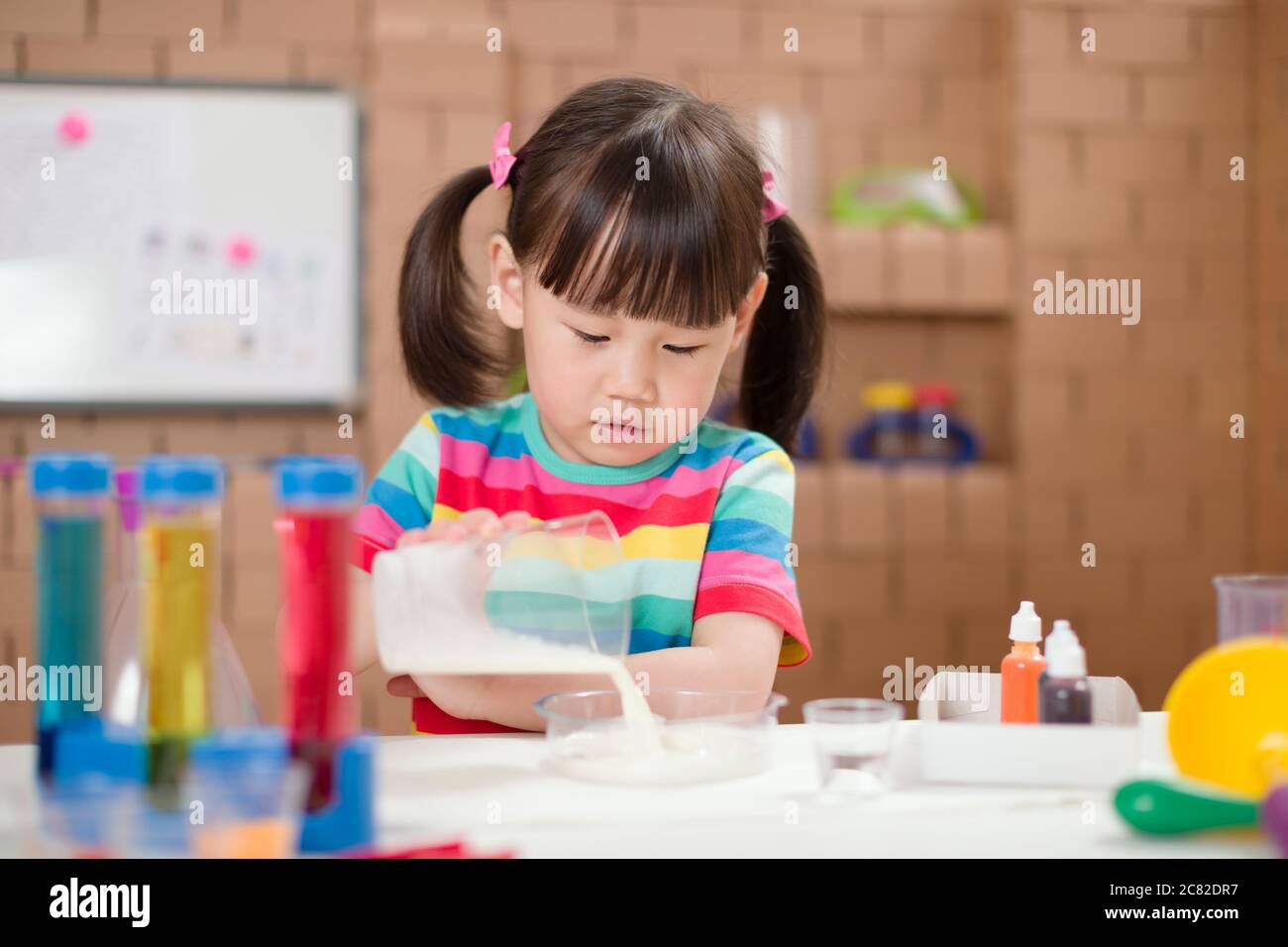 toddler girl play science experiments for homeschooling Stock Photo - Alamy