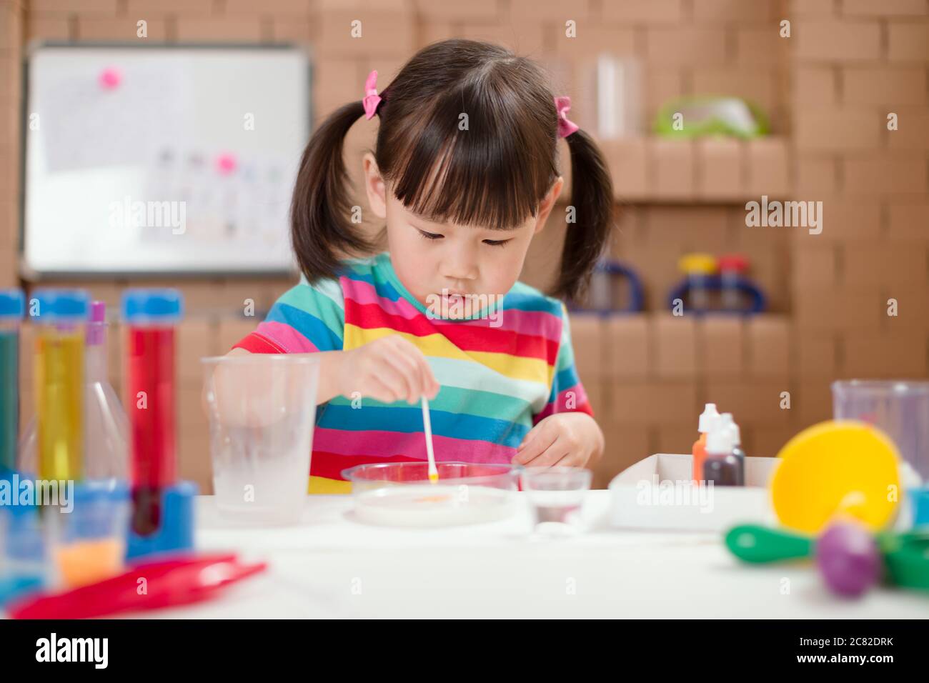toddler girl play science experiments for homeschooling Stock Photo - Alamy