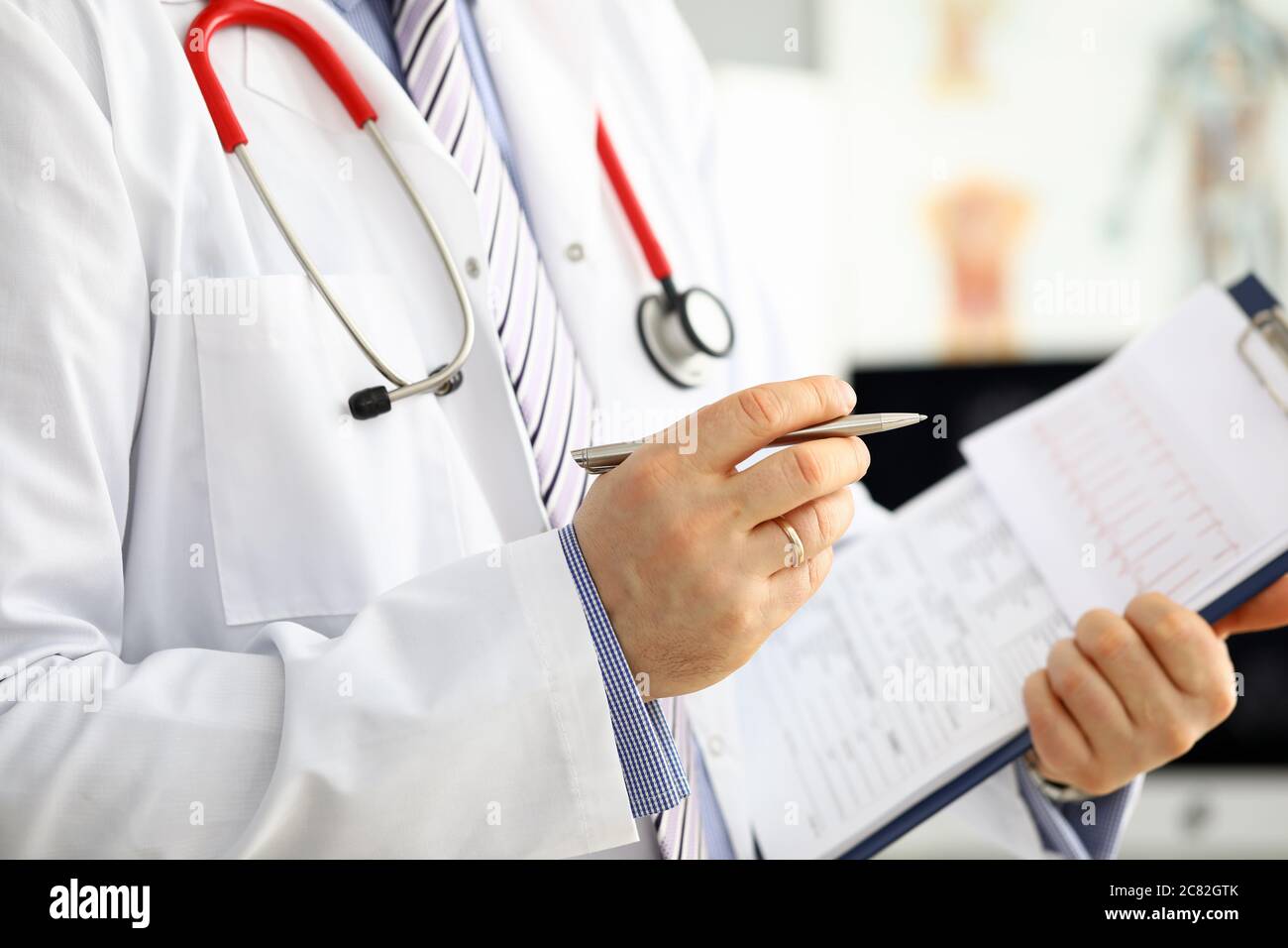 Male medicine doctor hand holding silver pen Stock Photo - Alamy