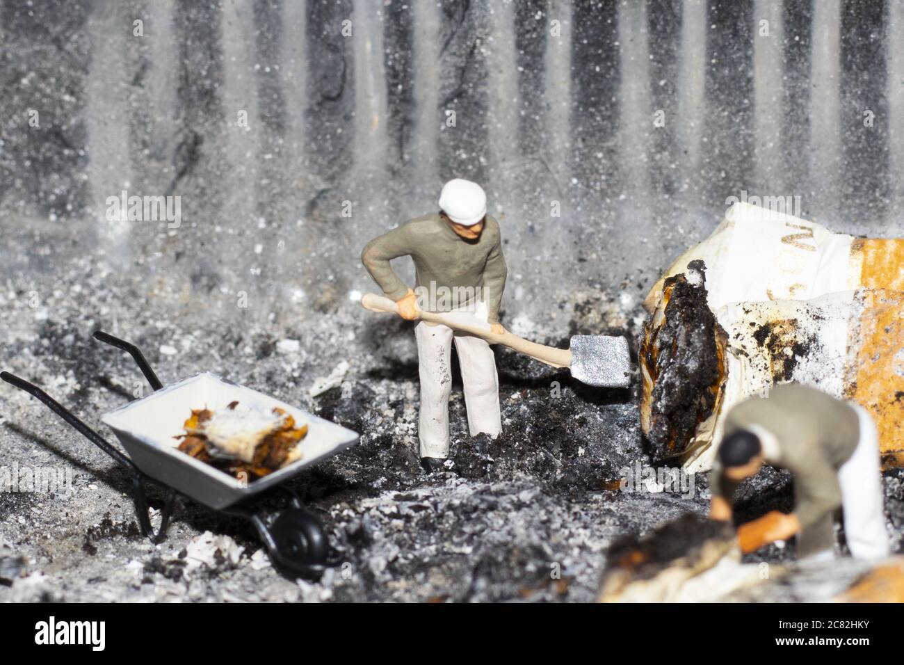 Unique scale model of miniature characters working in cigarette ashes ...