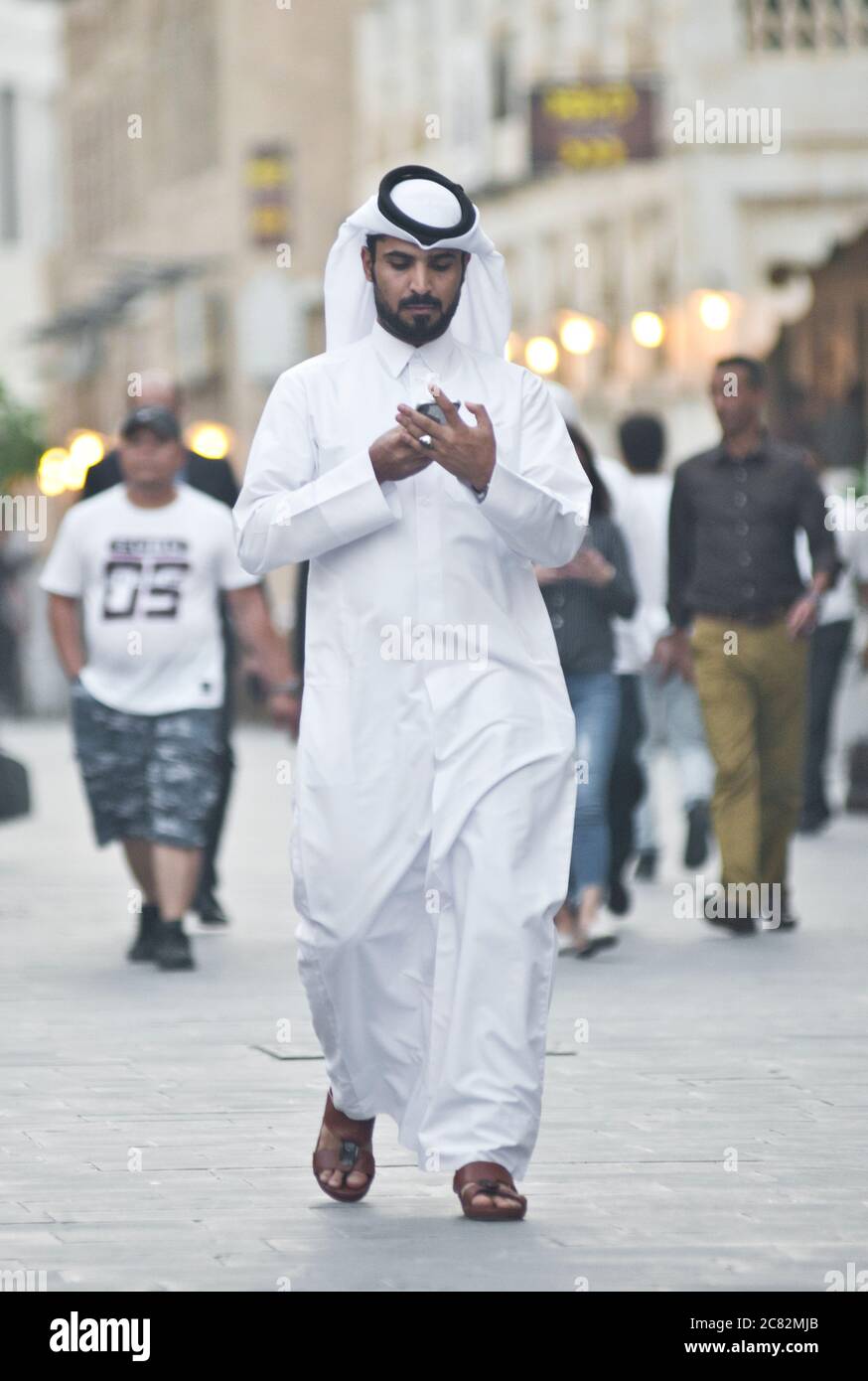 Muslim saudi man using a smartphone in Souq Waqif, Doha, Qatar Stock ...