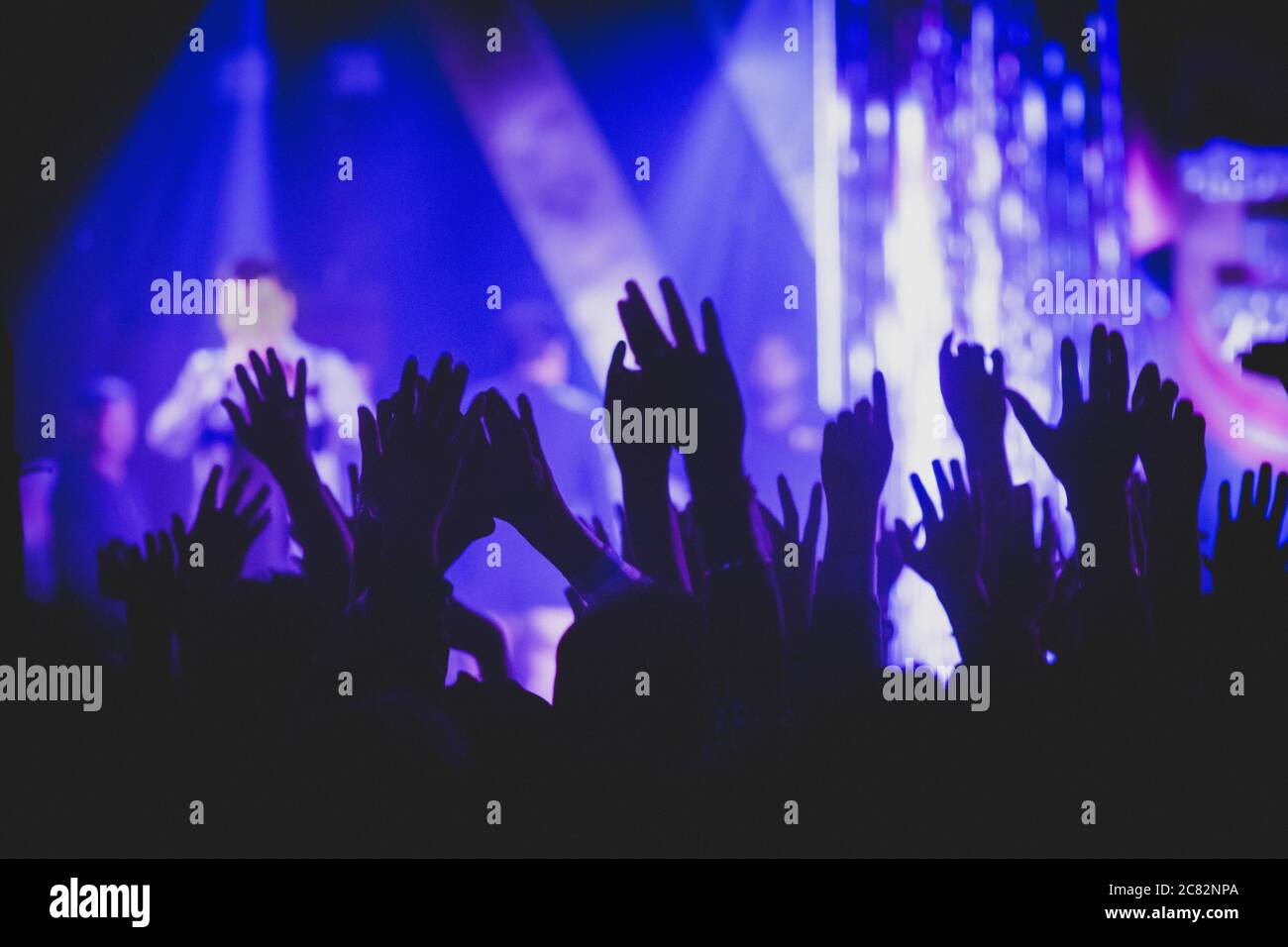 Crown rising hand in concert Stock Photo - Alamy