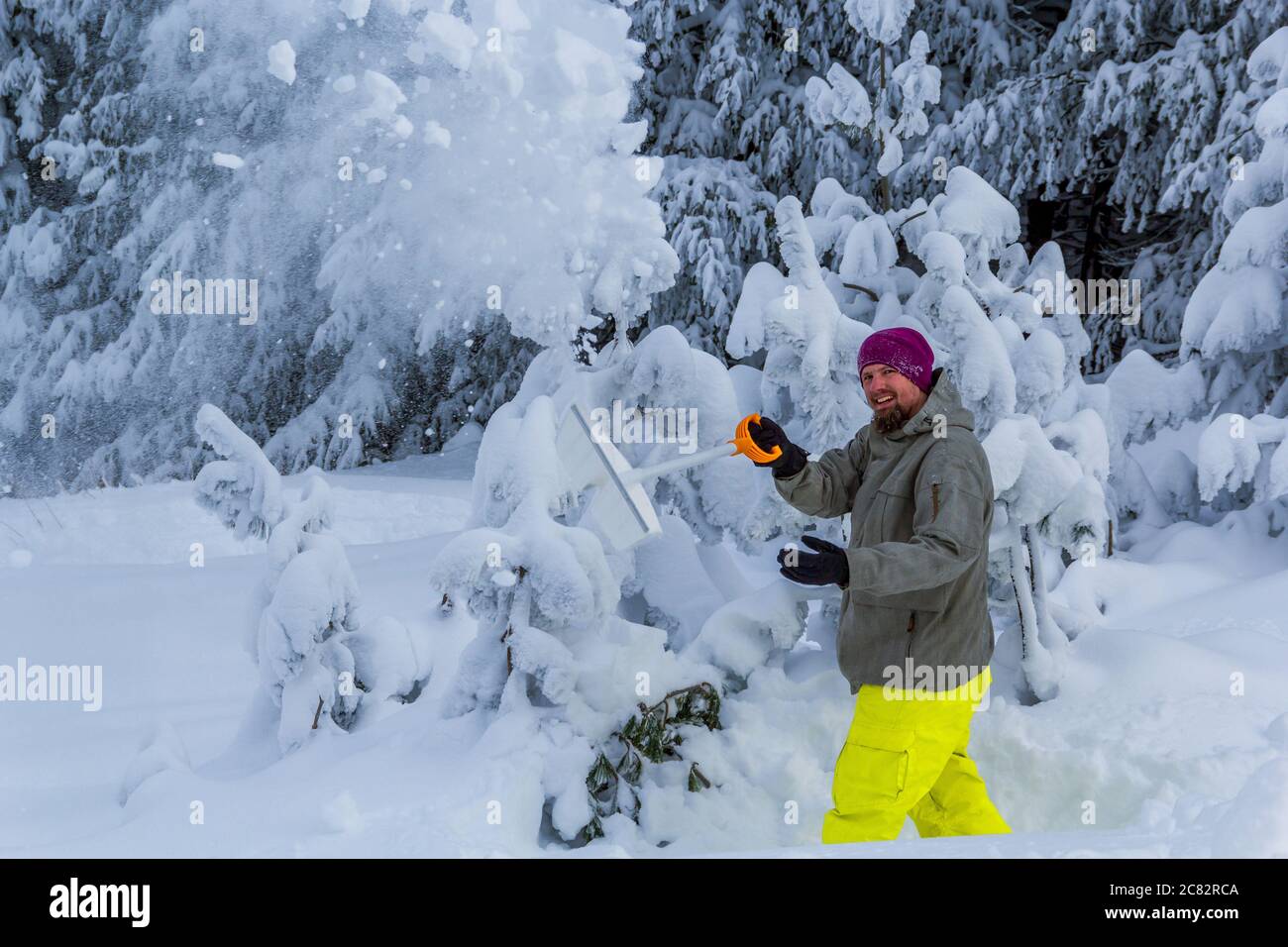 man clears snow from the mountains in december Stock Photo - Alamy
