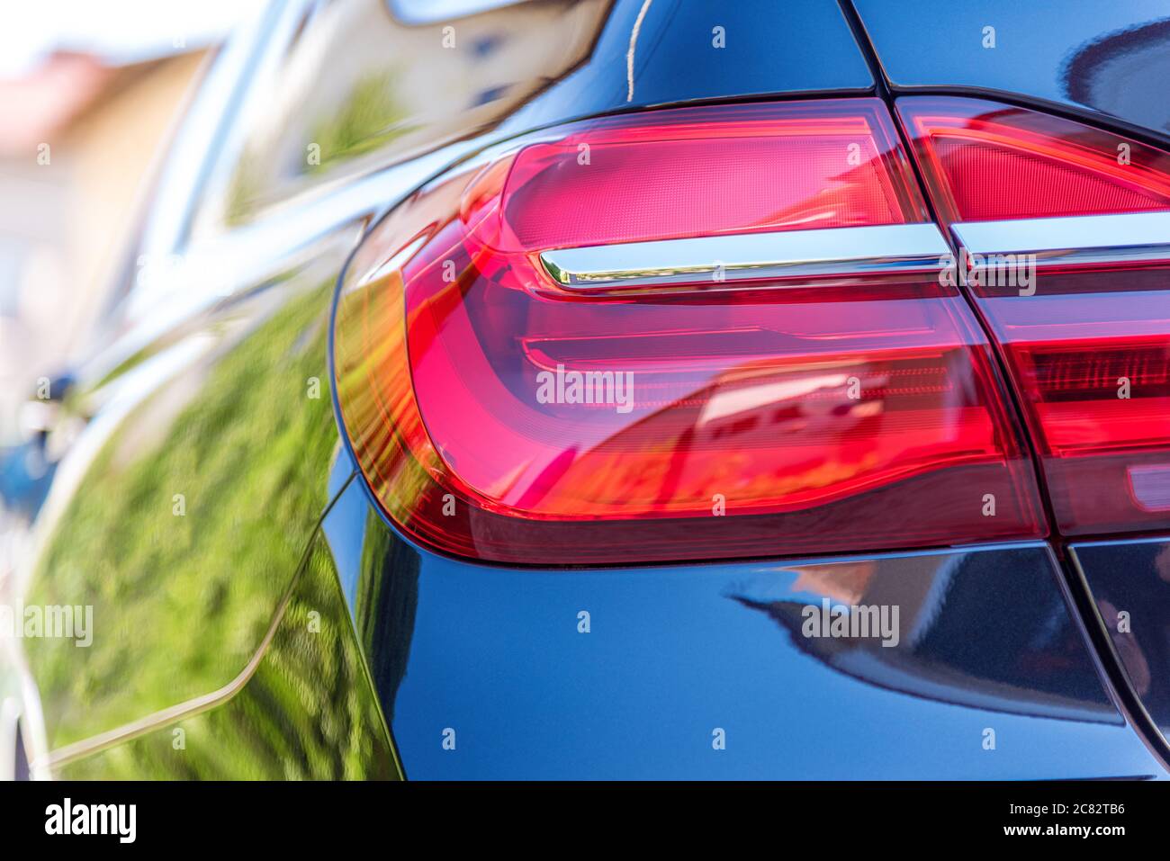 Car headlight. Back view of city car on blurred background Stock Photo ...