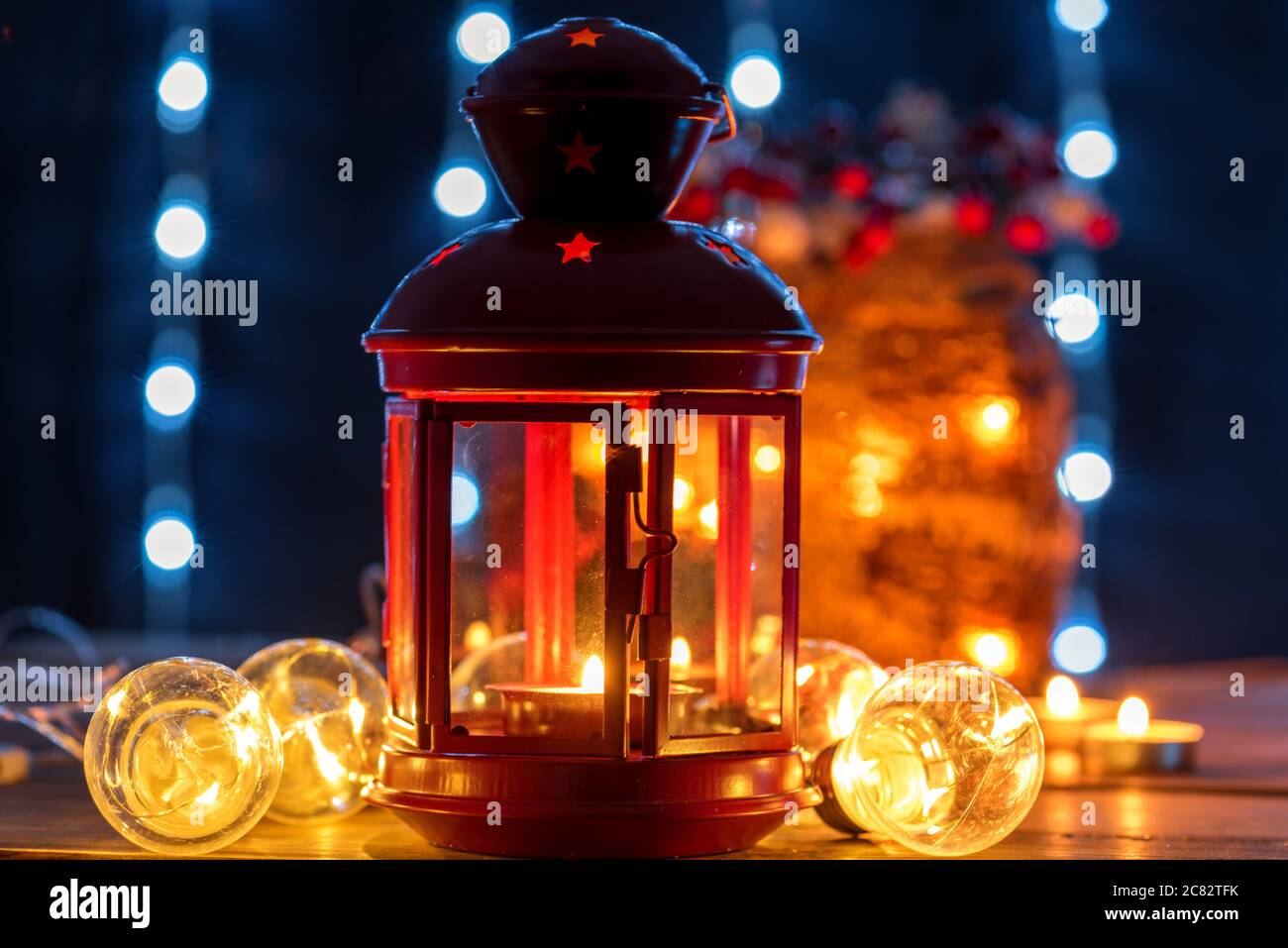 christmas lantern with candle on defocused lights background Stock ...
