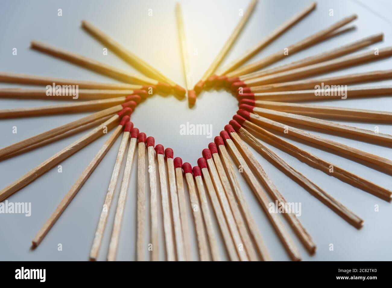 closeup of matchsticks arranged to form a heart shape with depth of ...