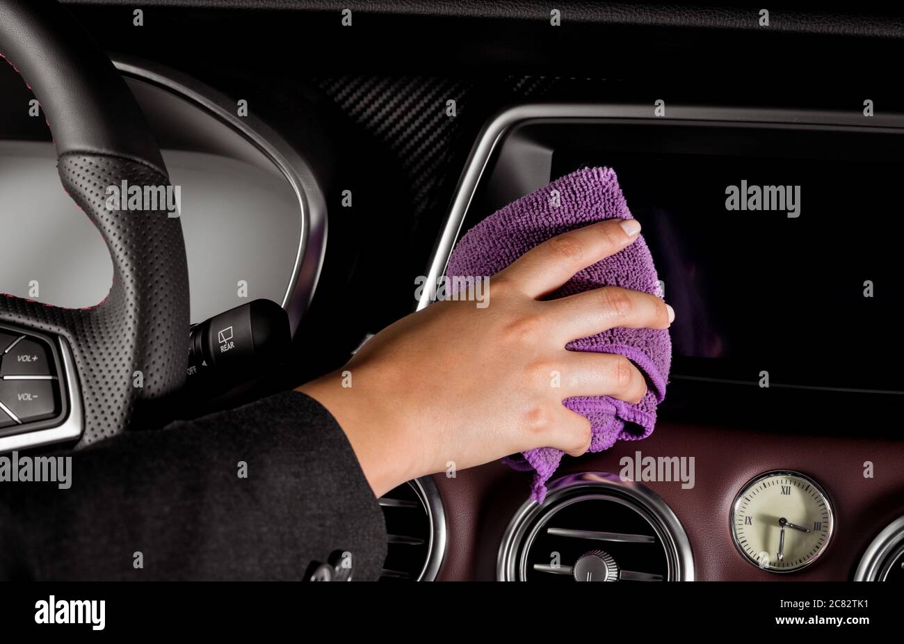 Closeup of a woman's wiping the touch screen monitor of a new SUV Stock ...