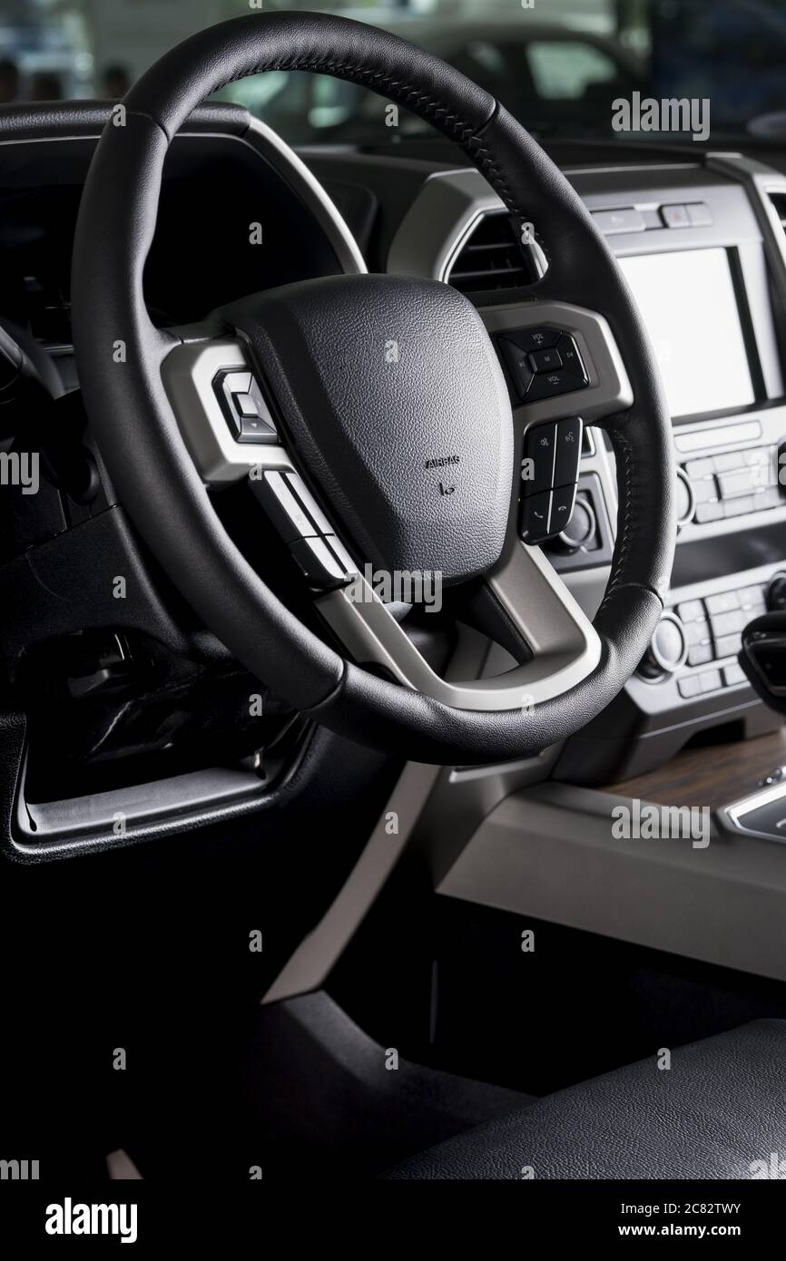 Vertical shot of leather-covered steering wheel of a new SUV car Stock ...