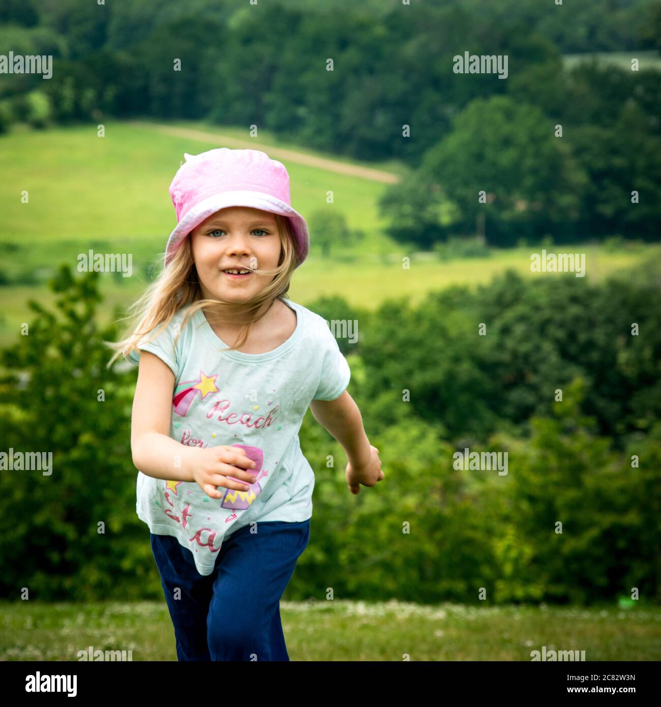 Happy child running in summertime. Adorable kid jogging and smiling ...