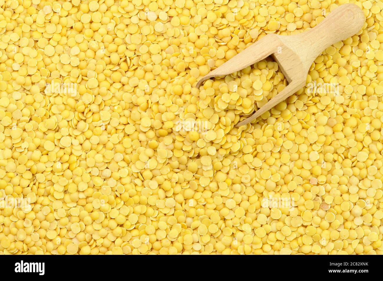 Yellow Lentils and wooden spoon from top Stock Photo - Alamy