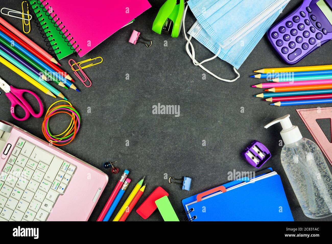 School supplies and COVID 19 prevention items. Top view frame on a ...